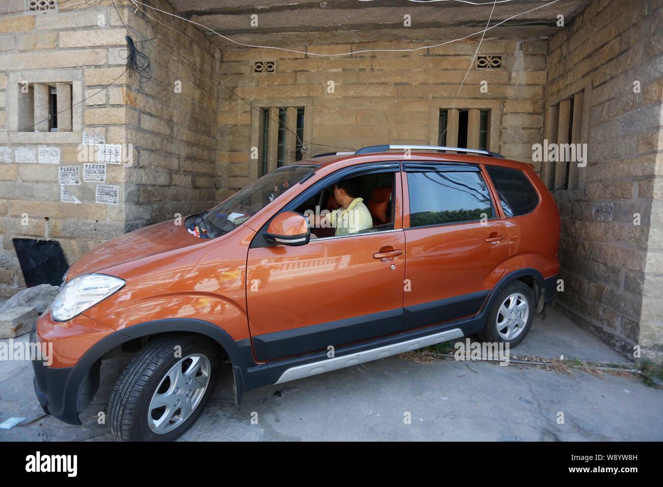 Chinese driver Chen Zhongliang demonstrates pulling his car out of a ...