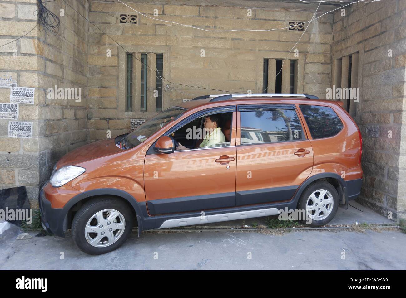 Chinese driver Chen Zhongliang demonstrates pulling his car out of a ...