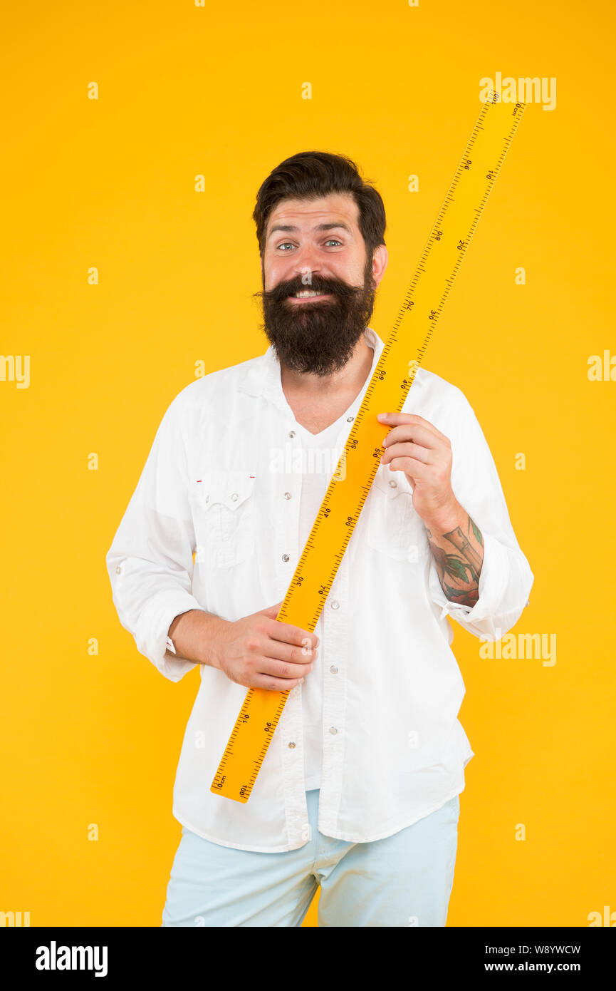 Man bearded hipster holding ruler. Measure length. Size tall and length ...
