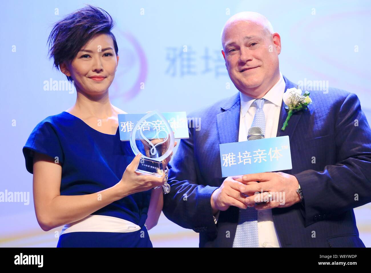 Singaporean singer Stefanie Sun, left, poses during a press conference ...