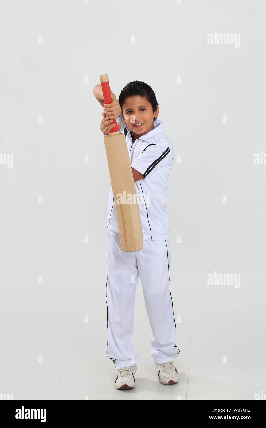 Boy playing cricket Stock Photo - Alamy