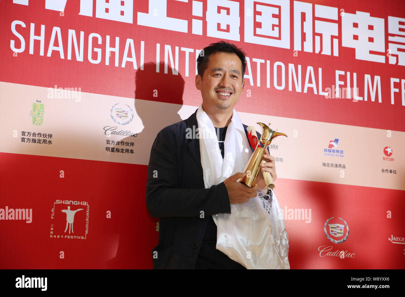 Chinese photographer Luo Pan holds his trophy of the Best ...