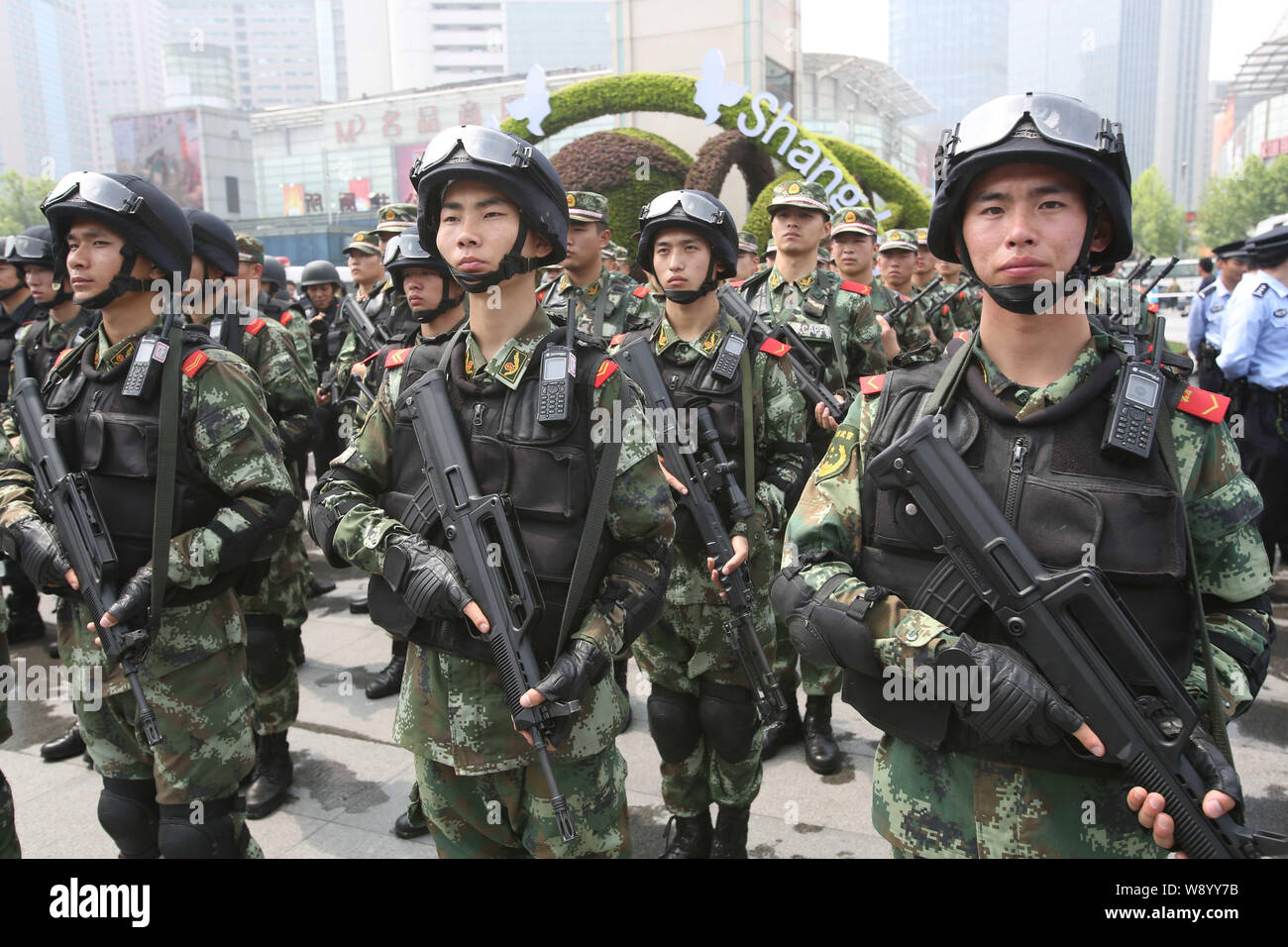 SWAT police officers armed with guns stand guard at the square of the ...