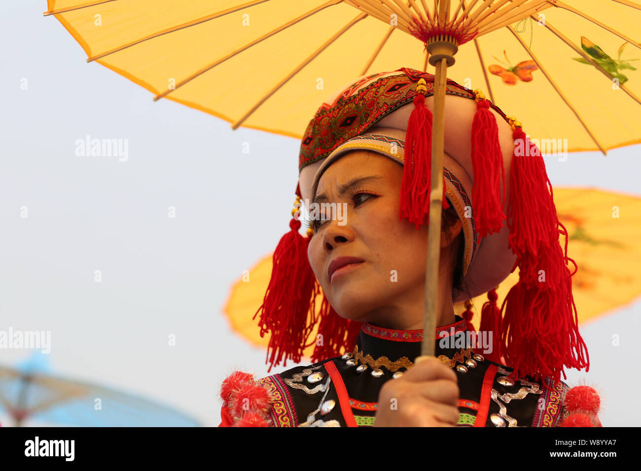 A Chinese performer dressed in a traditional costume of Dai ethnic ...