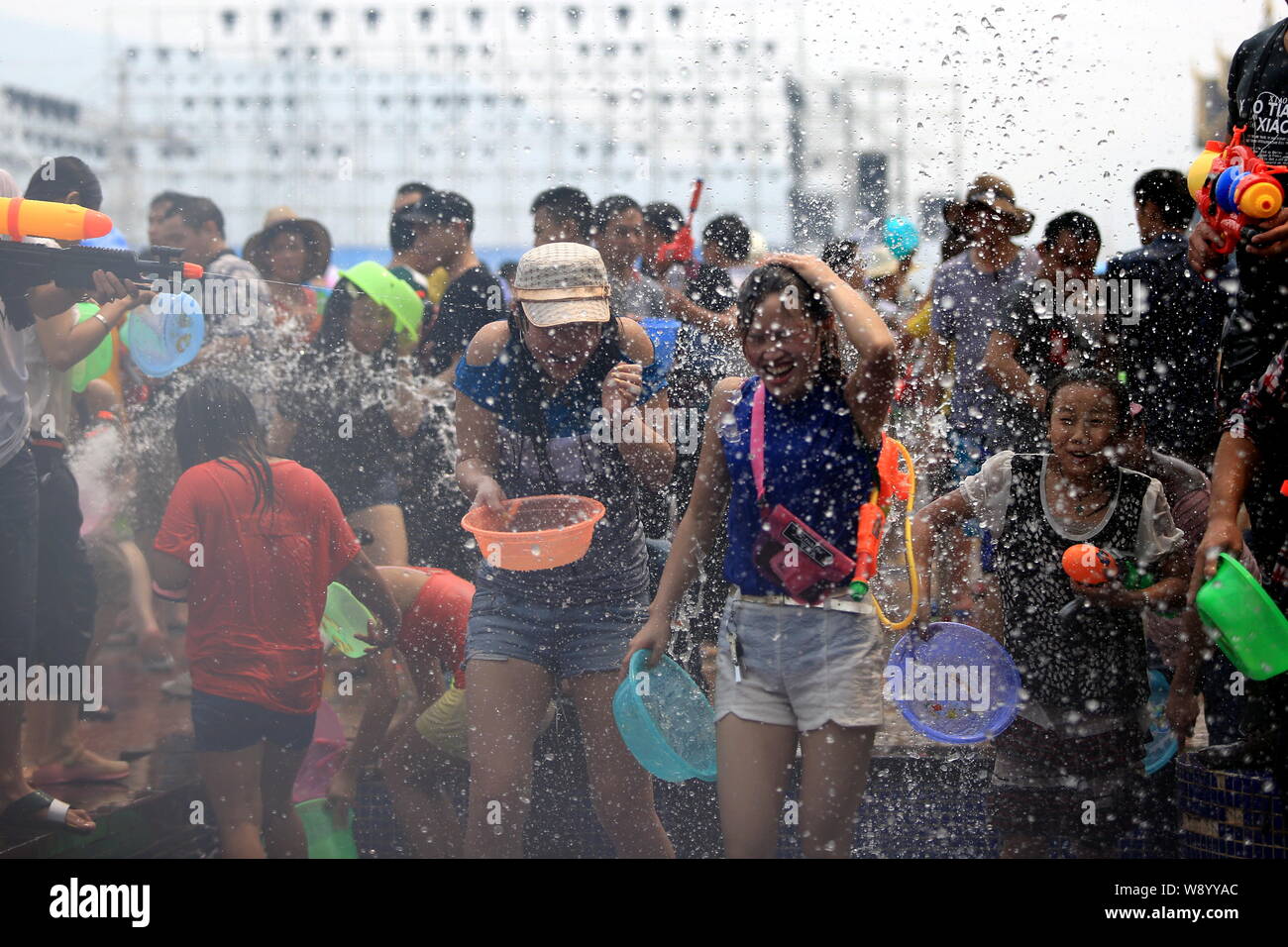 Crowds of local people splash water to celebrate the New Year of Dai ...