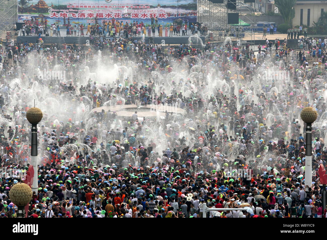 Crowds of local people splash water to celebrate the New Year of Dai ...