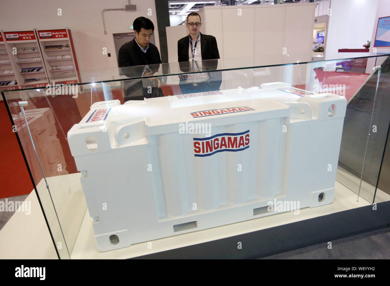 --FILE--Visitors look at a model of a container at the stand of Chinese ...