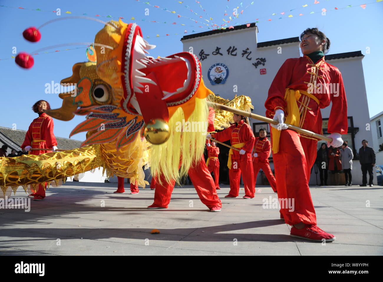 Chinese entertainers perform a dragon dance to celebrate upcoming ...
