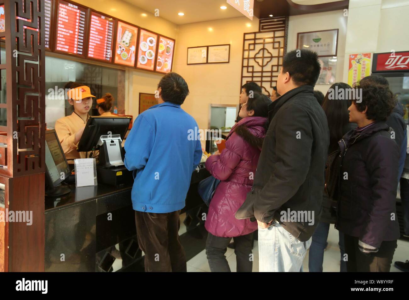 Customers queue up to buy steamed dumplings at the Qing Feng Steamed ...