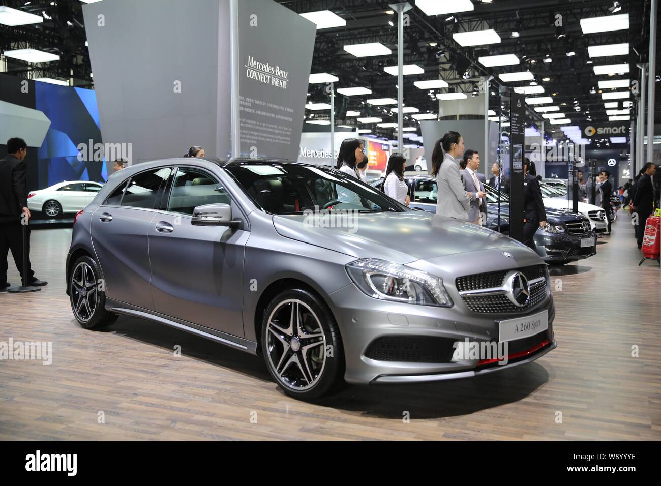 --FILE--Chinese employees stand next to Mercedes-Benz cars on display ...