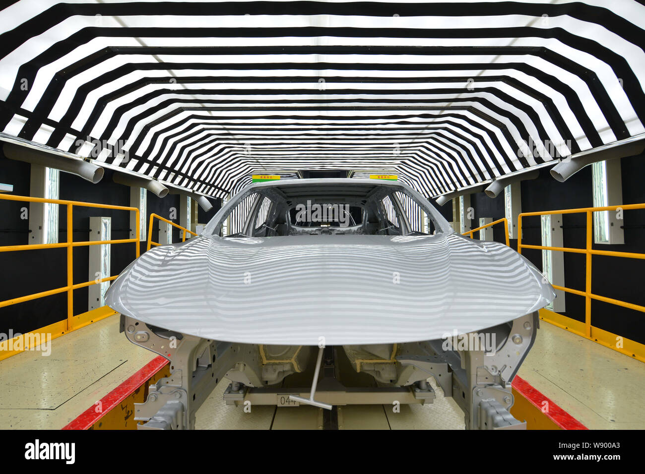A car is being examined at a plant of the Dongfeng Nissan Dalian Branch ...