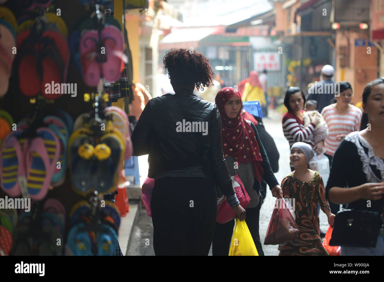 African women and local Chinese residents walk in a market at Africa ...