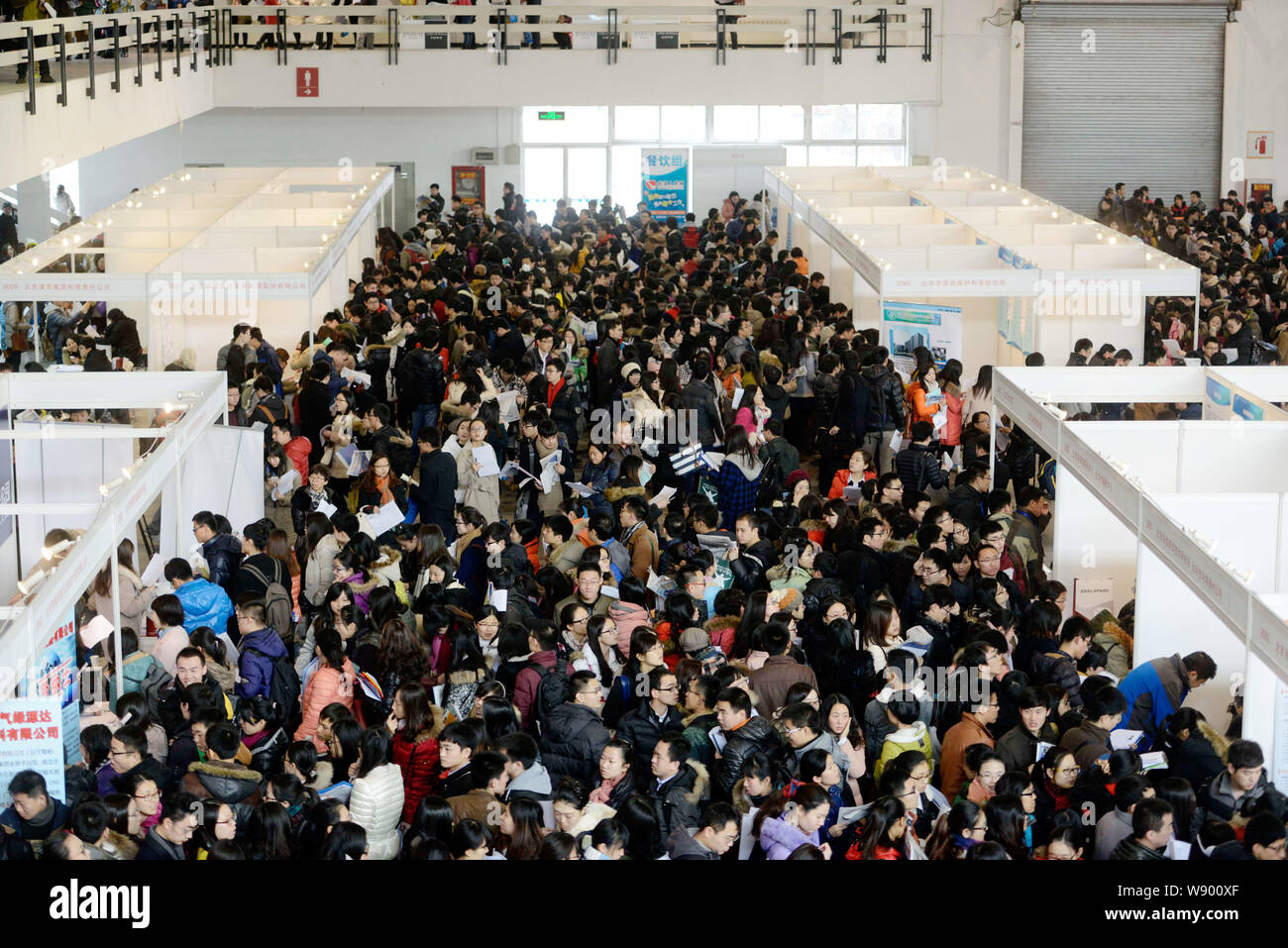 --FILE--Chinese graduates crowd stalls at a job fair in Beijing, China ...