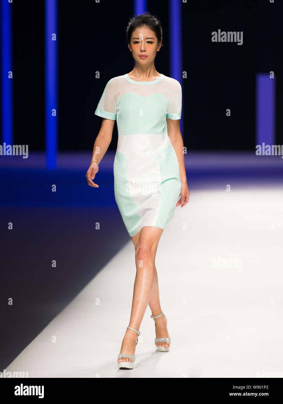 A model displays a new creation by designer Yuan Bing at the VISCAP ...