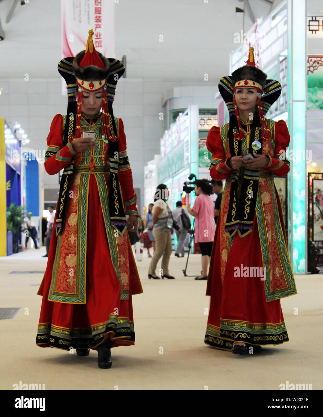 Two models wearing folk costumes are seen at China-Eurasia Expo in ...