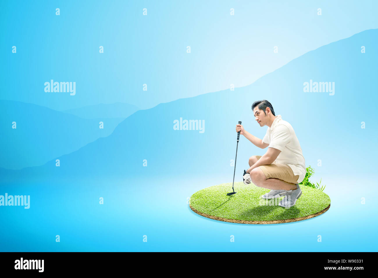 Asian man with putter golf crouching and look at a distance on the ...