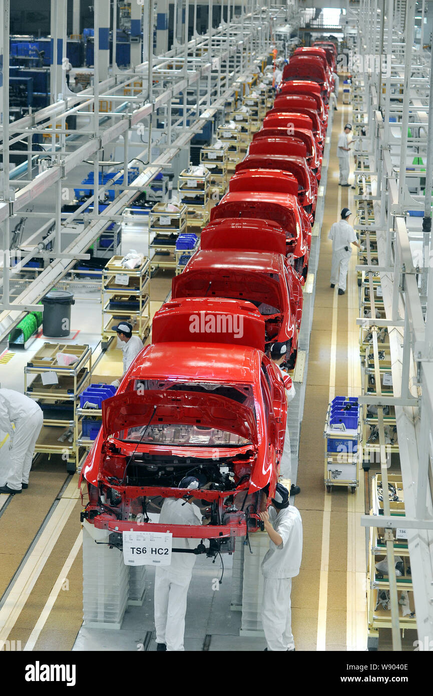 --FILE--Chinese workers assemble cars on the assembly line at the auto ...