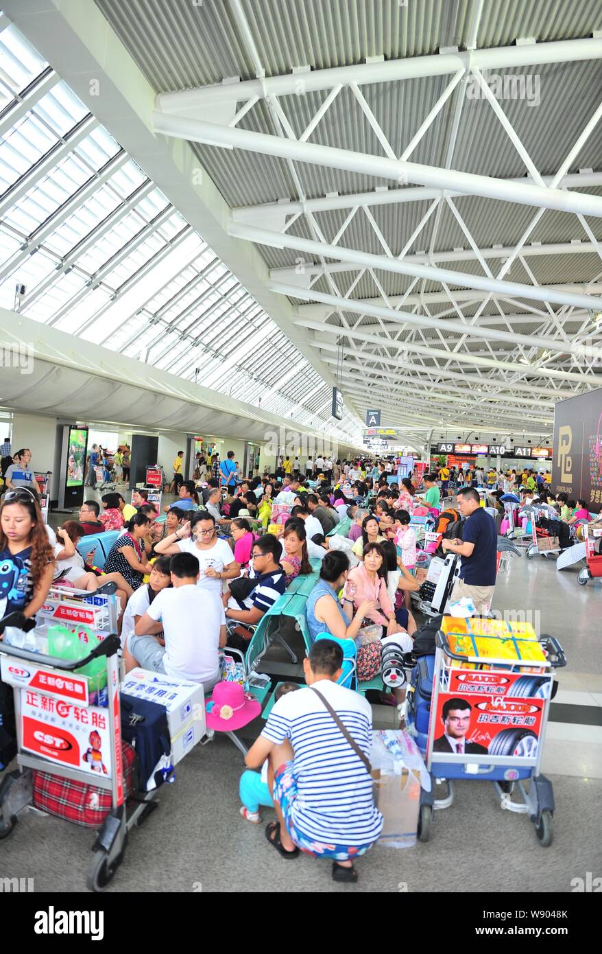 --FILE--Passengers wait at the terminal of the Sanya Phoenix ...