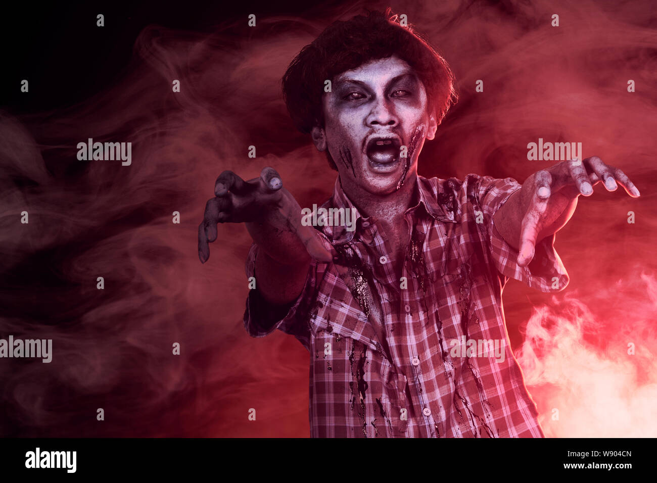 Scary zombies with blood and wound on his body walking amid the dark ...