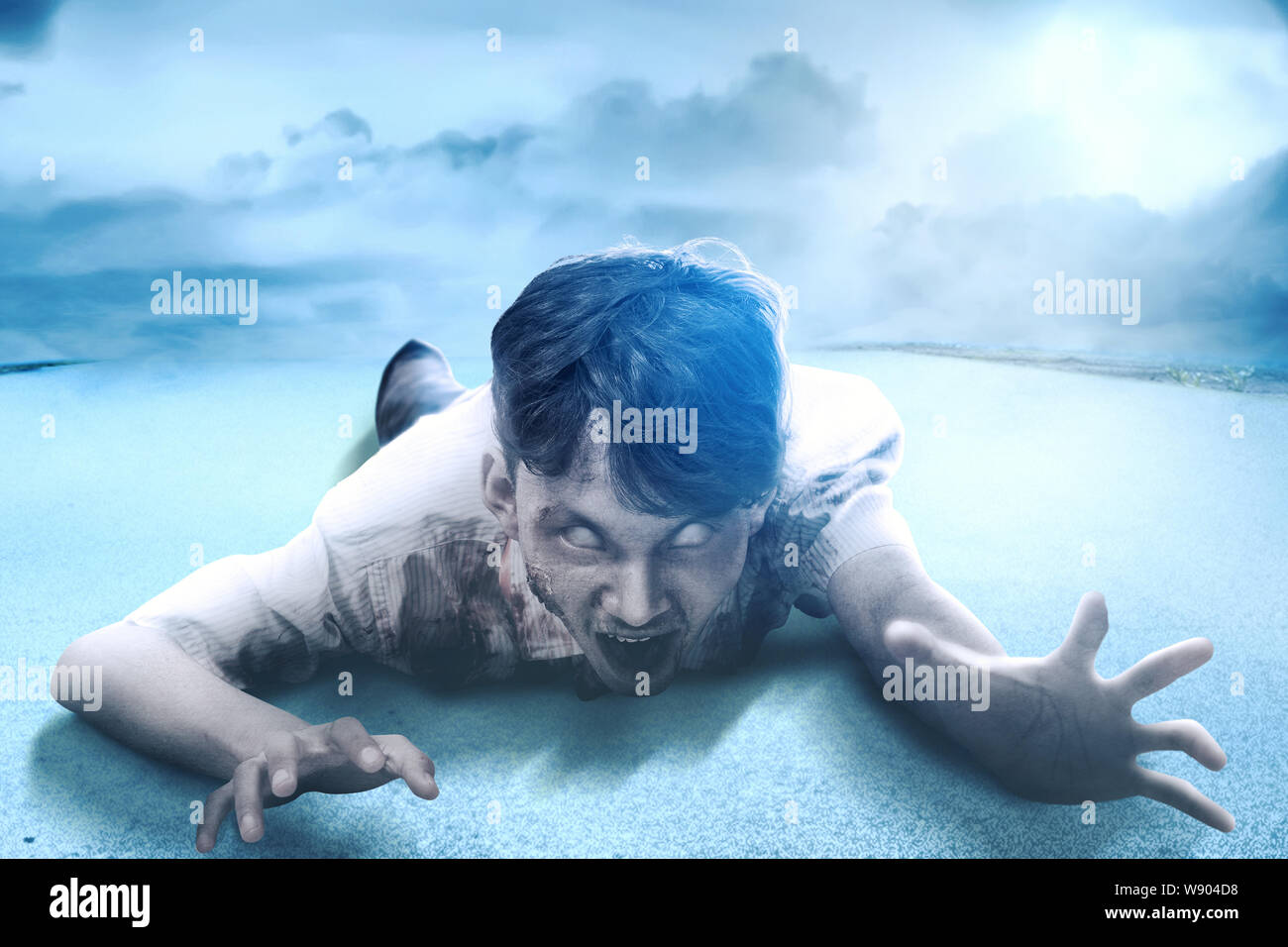 Scary zombies with blood and wound on his body crawling on the asphalt ...