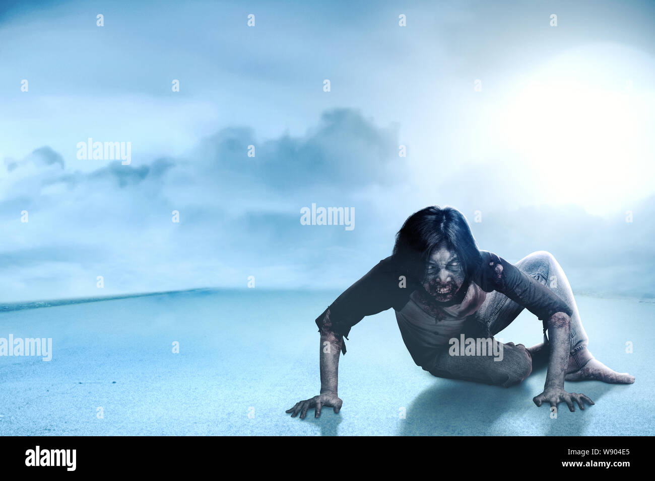 Scary zombies with blood and wound on his body crawling on the asphalt ...