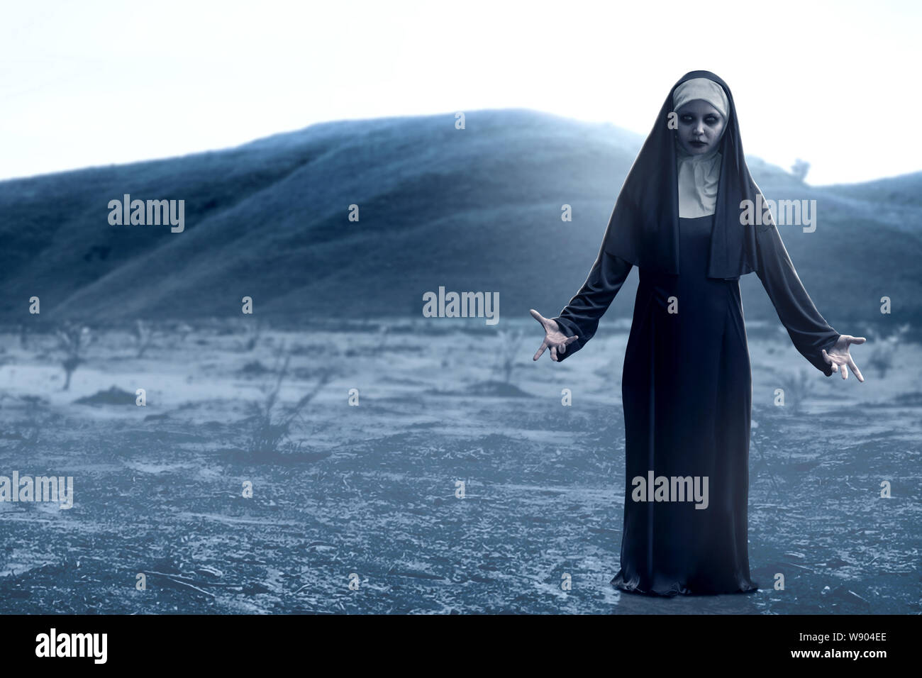 Frightening devil nun on the spooky hills. Halloween concept Stock ...