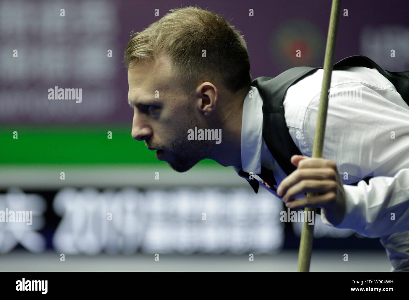 Judd Trump of England considers a shot to Tom Ford of England in their ...