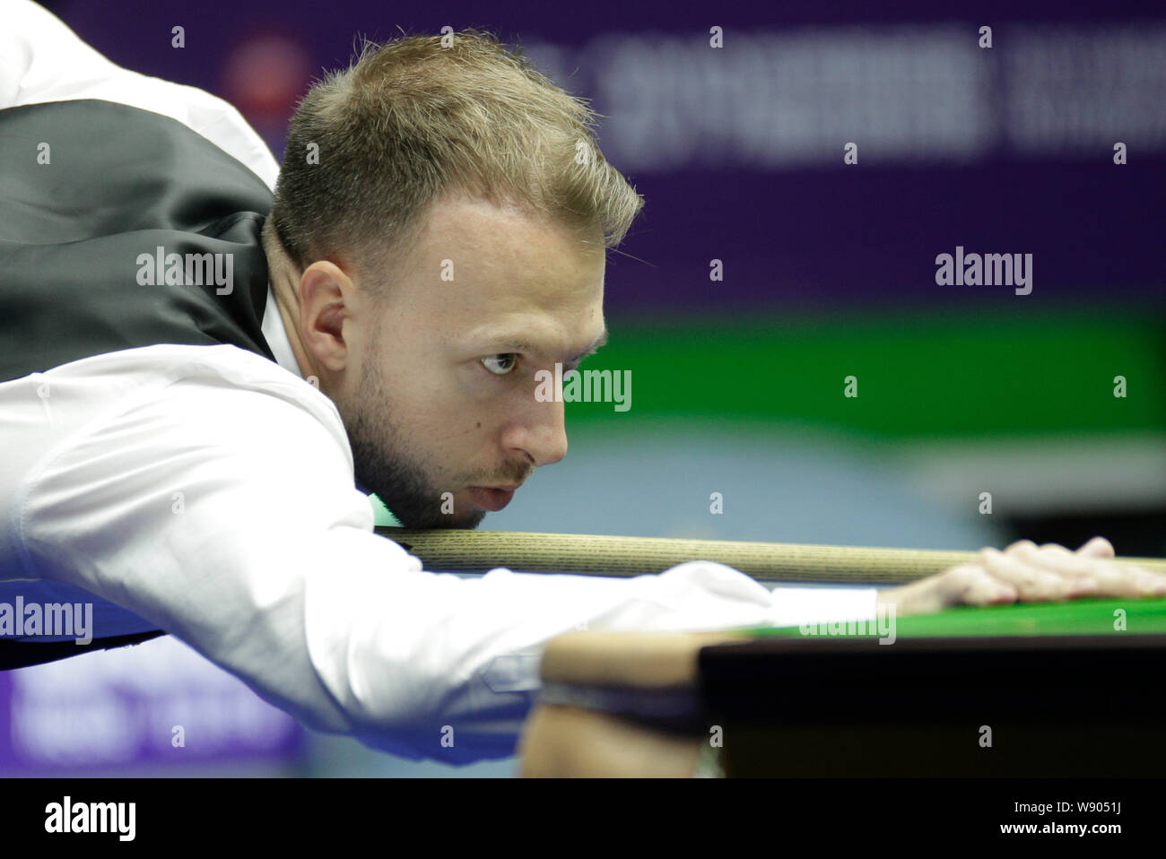 Judd Trump of England plays a shot to Tom Ford of England in their ...