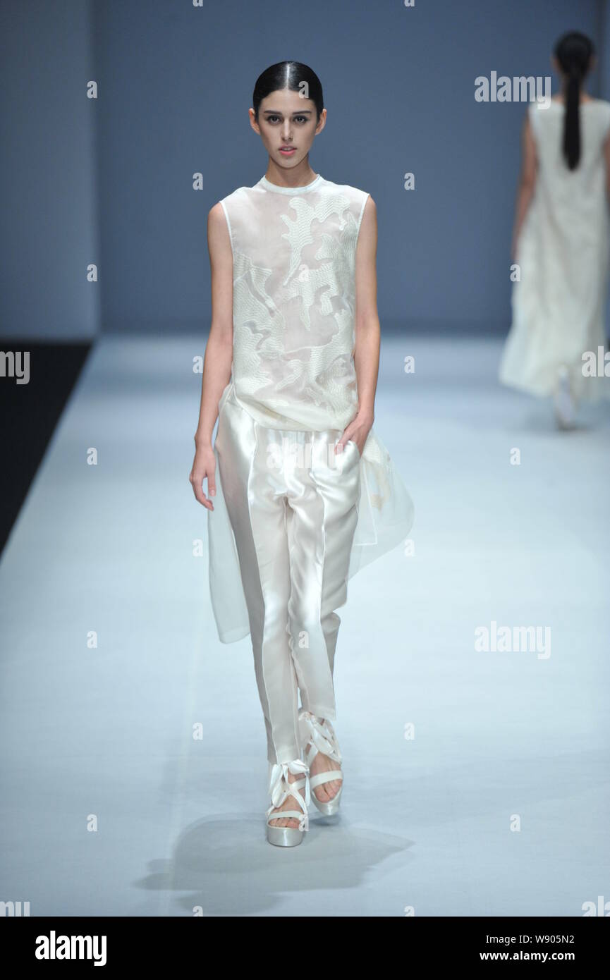 A model displays a new creation by designer Yi Ya at the Y¯iLuck Yi Ya ...