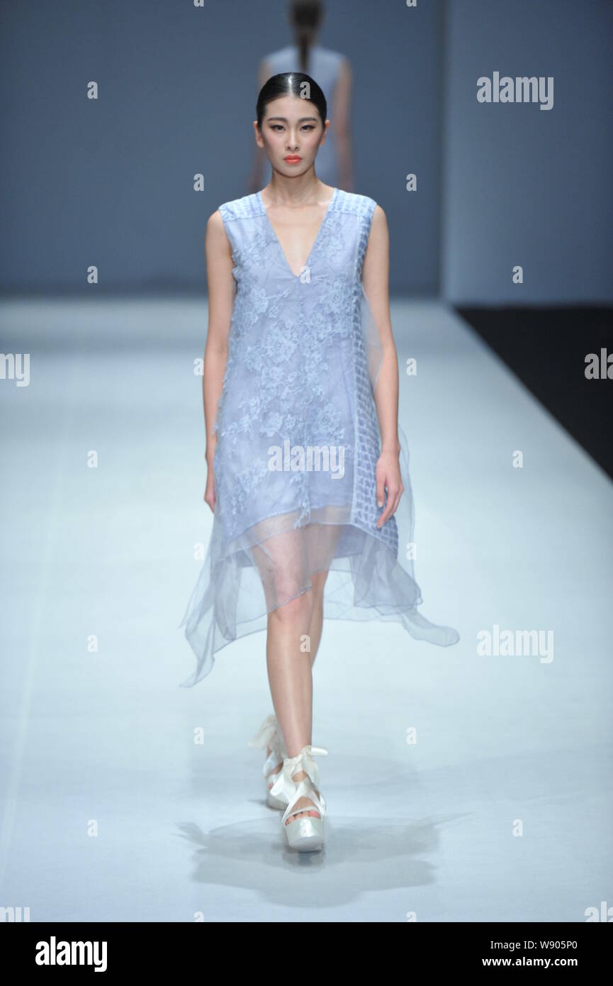 A model displays a new creation by designer Yi Ya at the Y¯iLuck Yi Ya ...