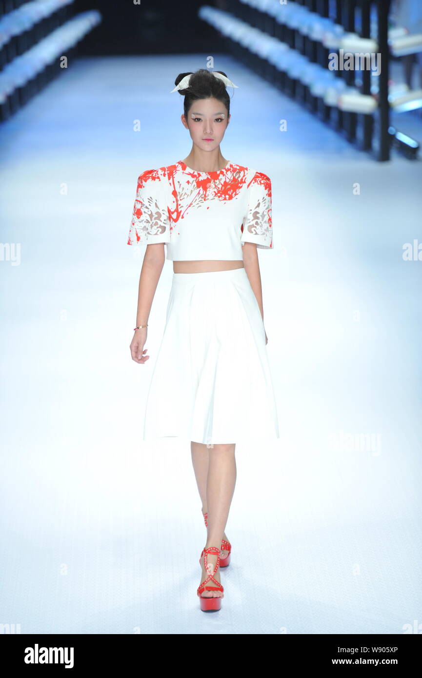 A model displays a new creation by designer Liu Wei at the Toray Liu ...