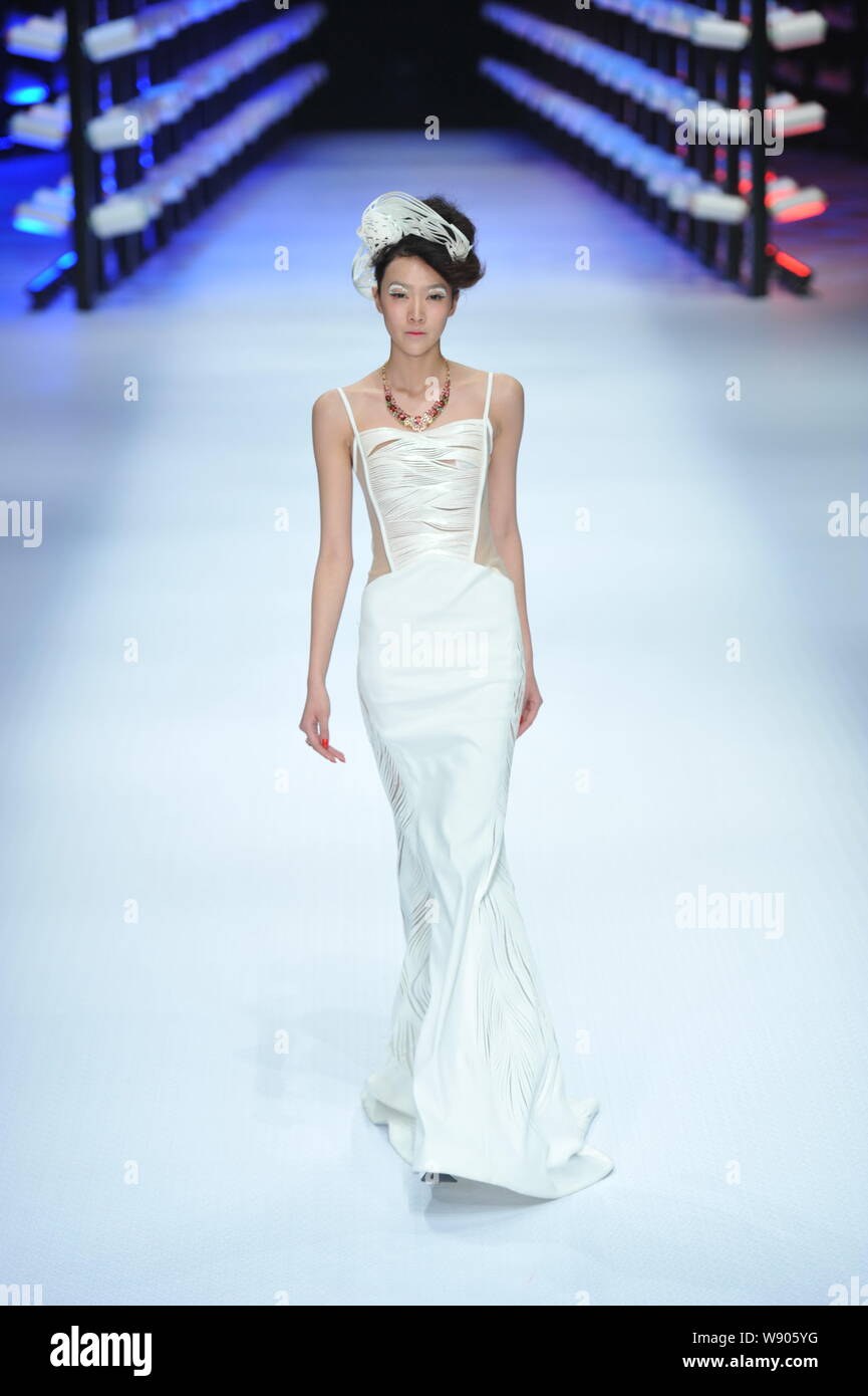 A model displays a new creation by designer Liu Wei at the Toray Liu ...