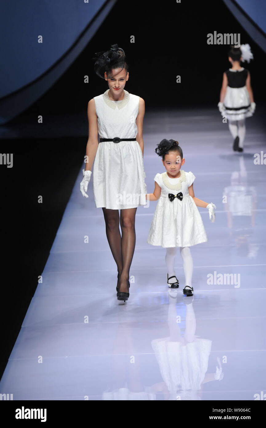 Models display new creations by designer Dong Wenmei at the Dong Wenmei ...