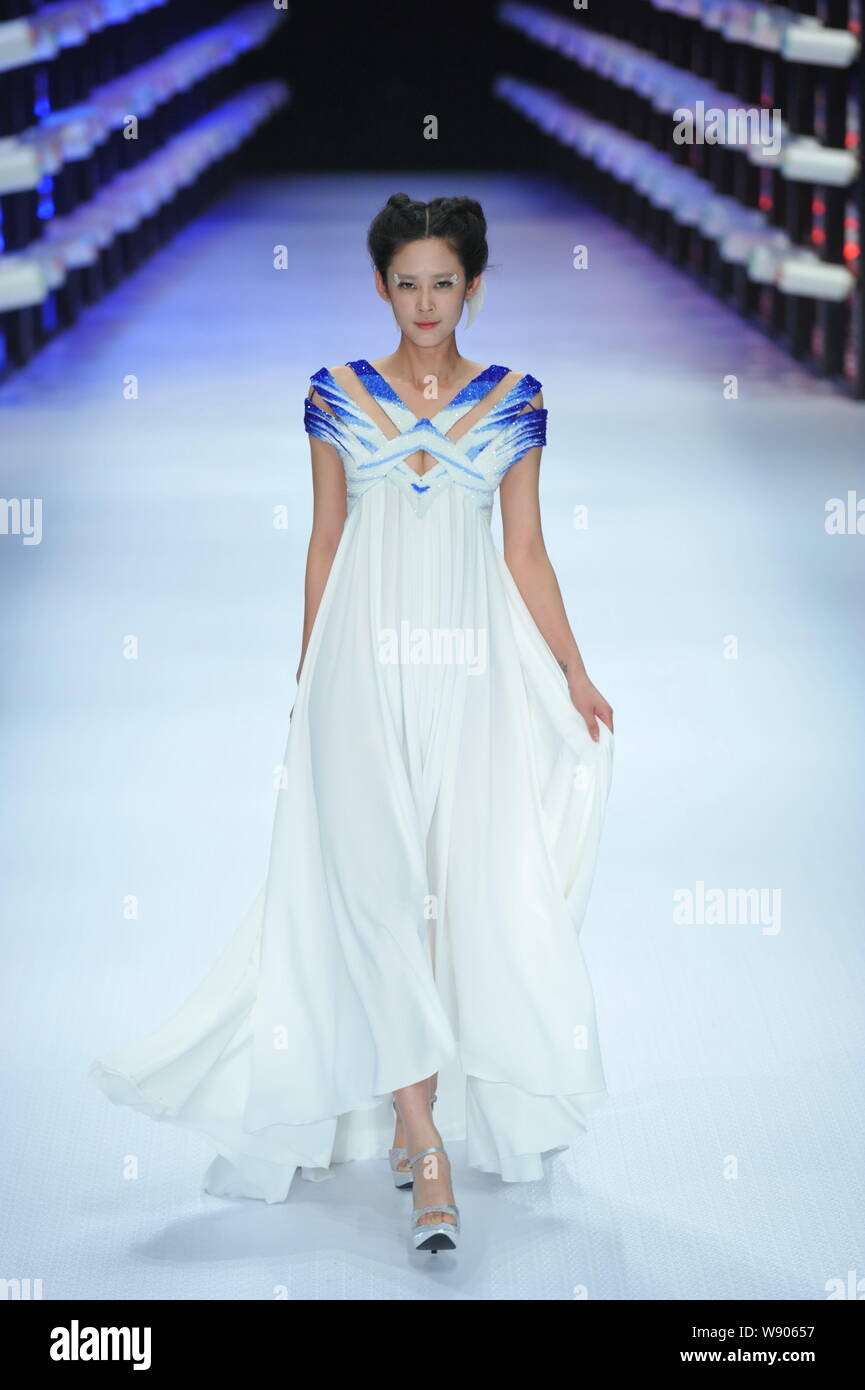A model displays a new creation by designer Liu Wei at the Toray Liu ...