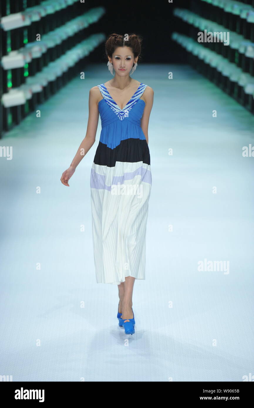 A model displays a new creation by designer Liu Wei at the Toray Liu ...