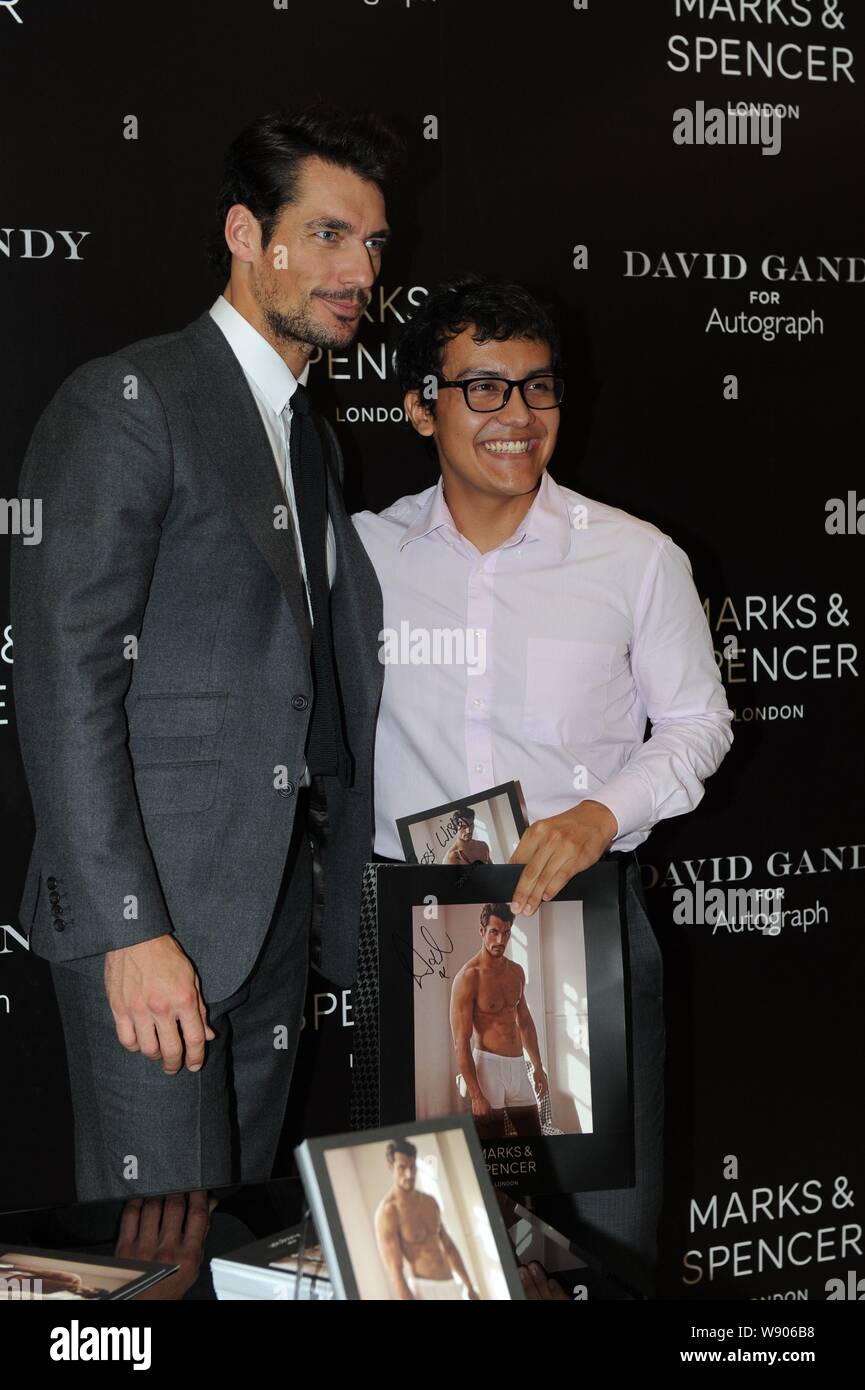 British model David Gandy, left, poses with a fan during a fan meeting ...