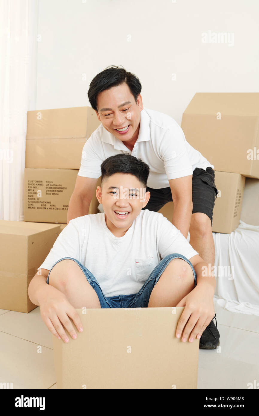 Father and son playing empty boxes Stock Photo - Alamy