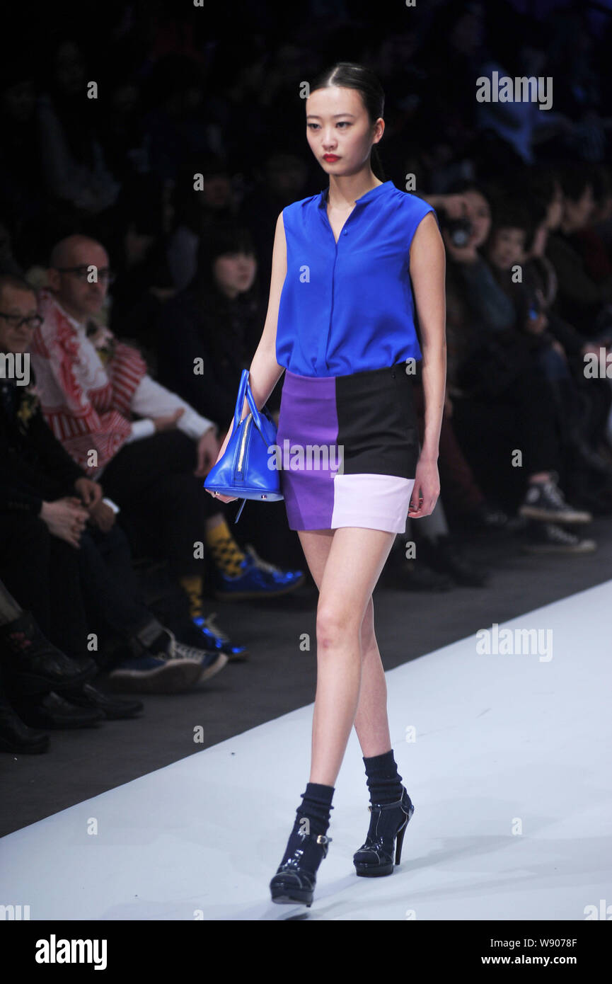 A model displays a creation at the W.S.M 2014 China Knitwear Fashion ...