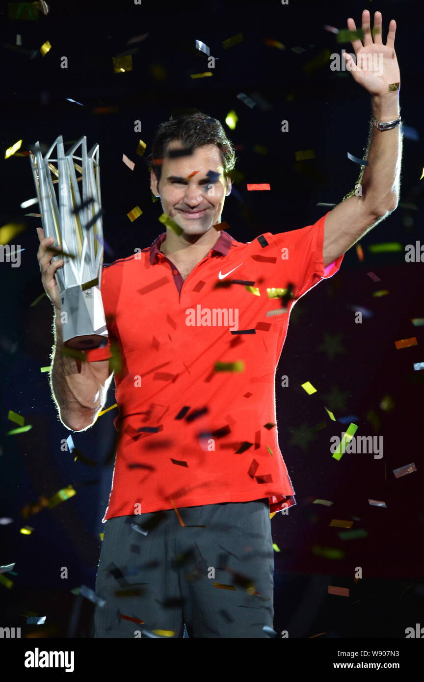 Roger Federer of Switzerland poses with his champion trophy at the ...
