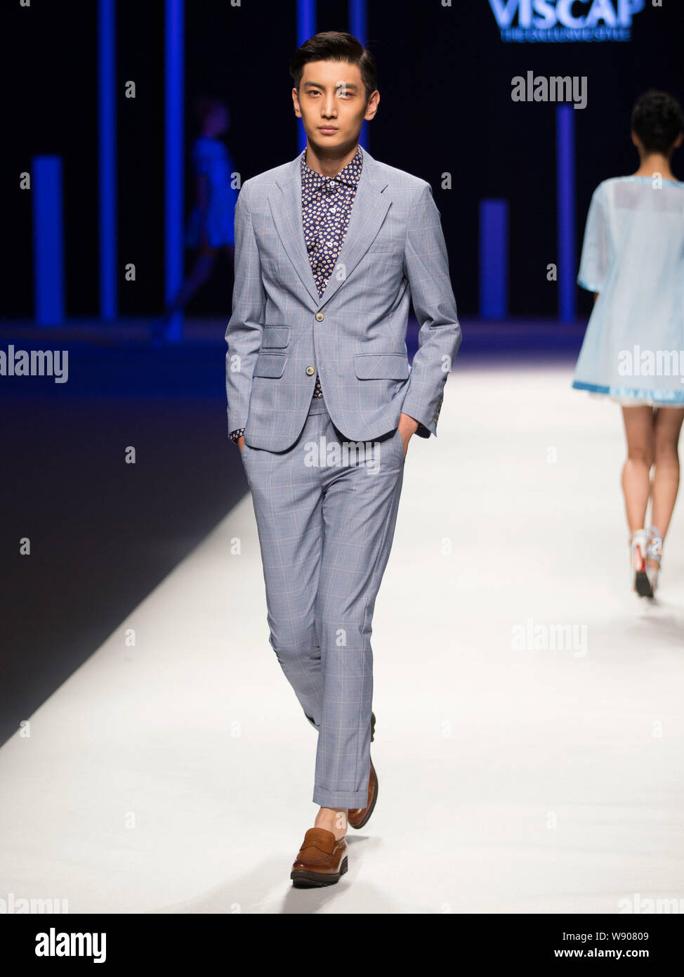 A model displays a new creation by designer Yuan Bing at the VISCAP ...