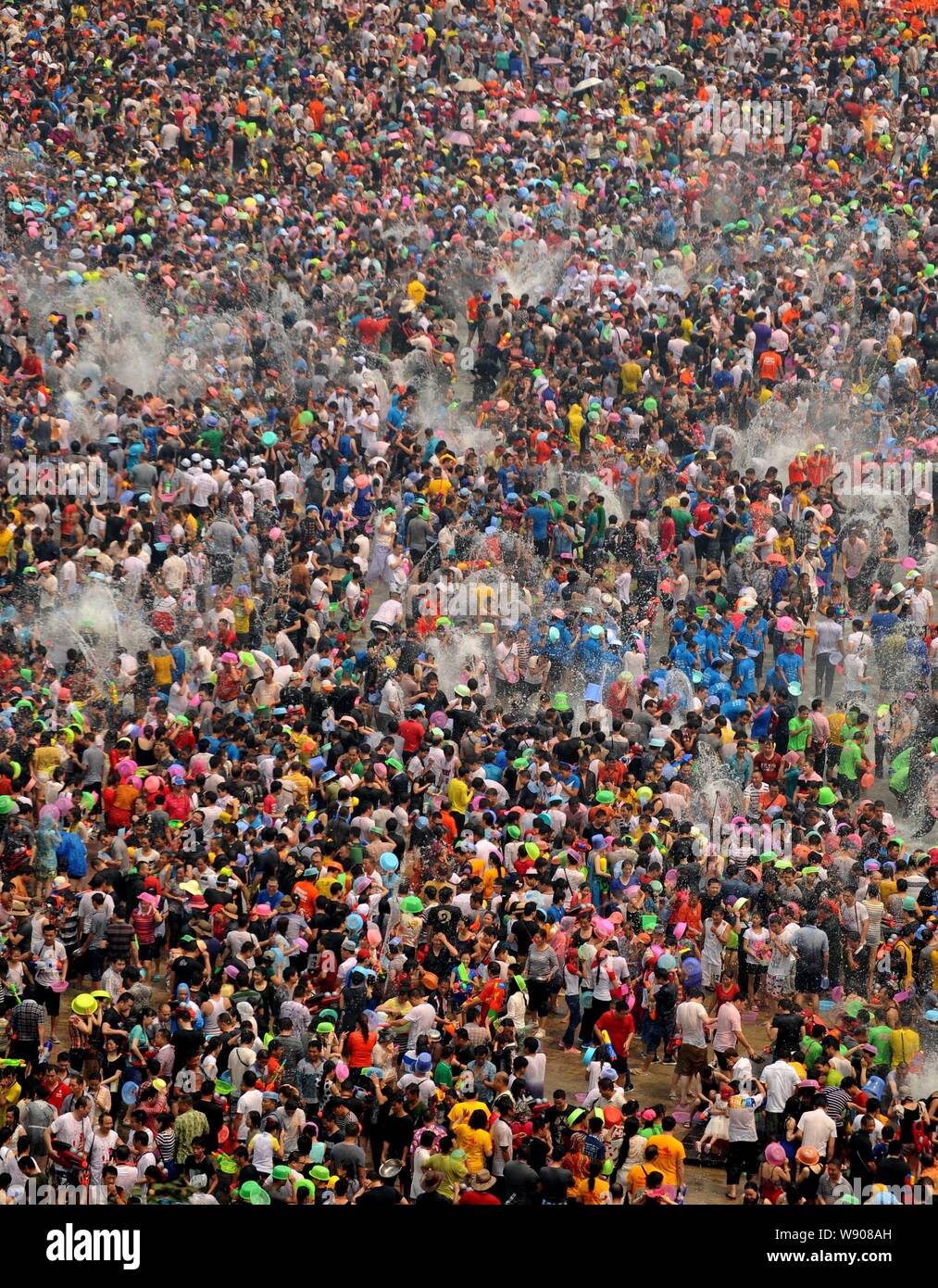 Crowds of local people splash water to celebrate the New Year of Dai ...