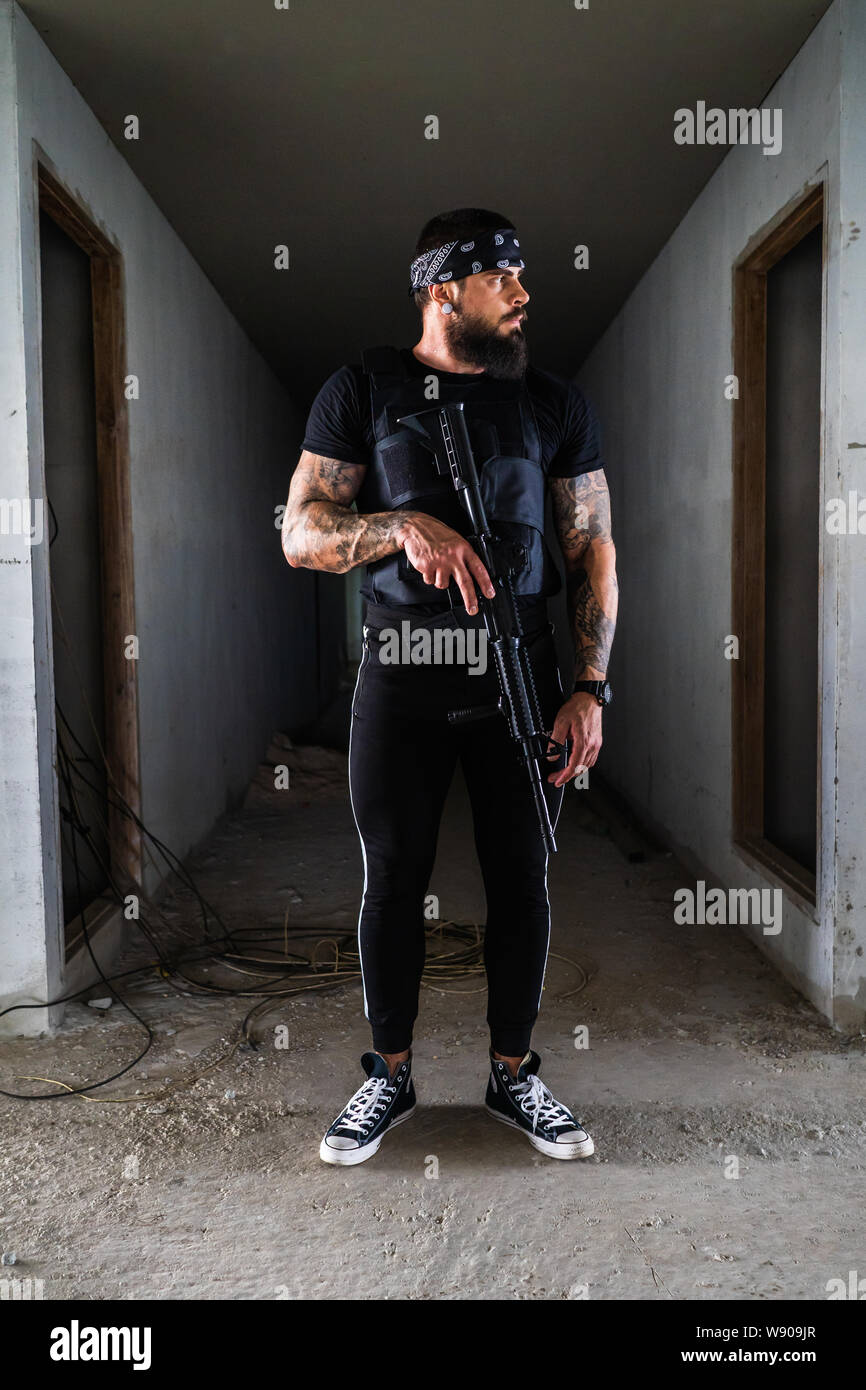 A character from an Airsoft game is depicted in a vertical photograph ...