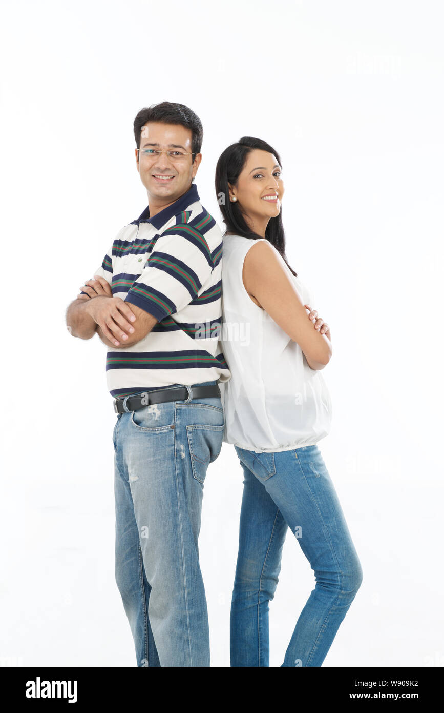 Couple standing back to back Stock Photo - Alamy