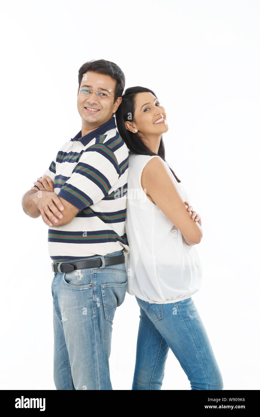 Couple standing back to back Stock Photo - Alamy