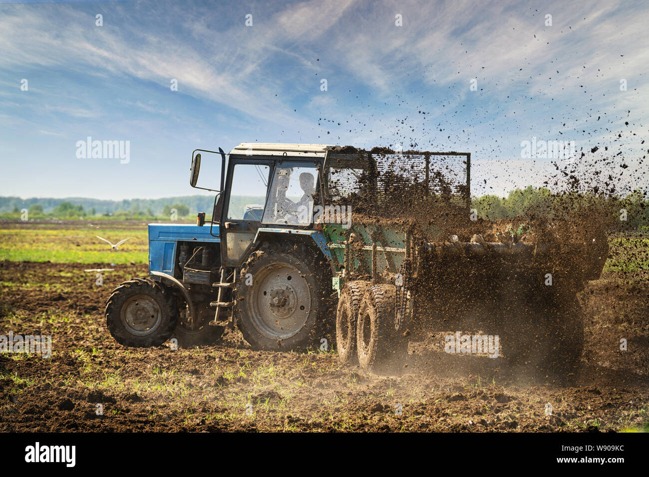 Field tractor at work. Rural industrial landscape Stock Photo - Alamy