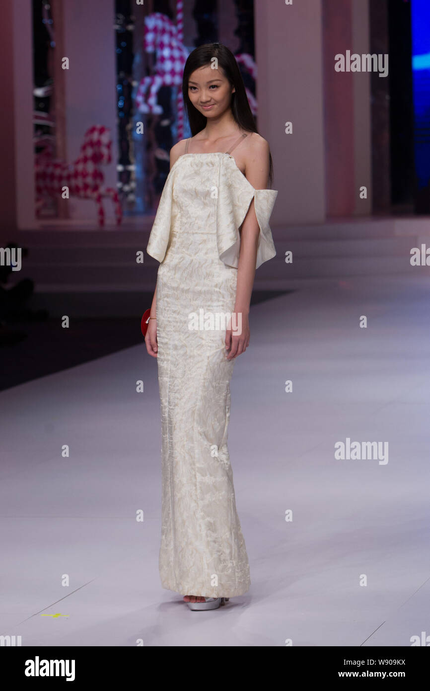 A model displays a new creation at the Final of the 9th China Super ...