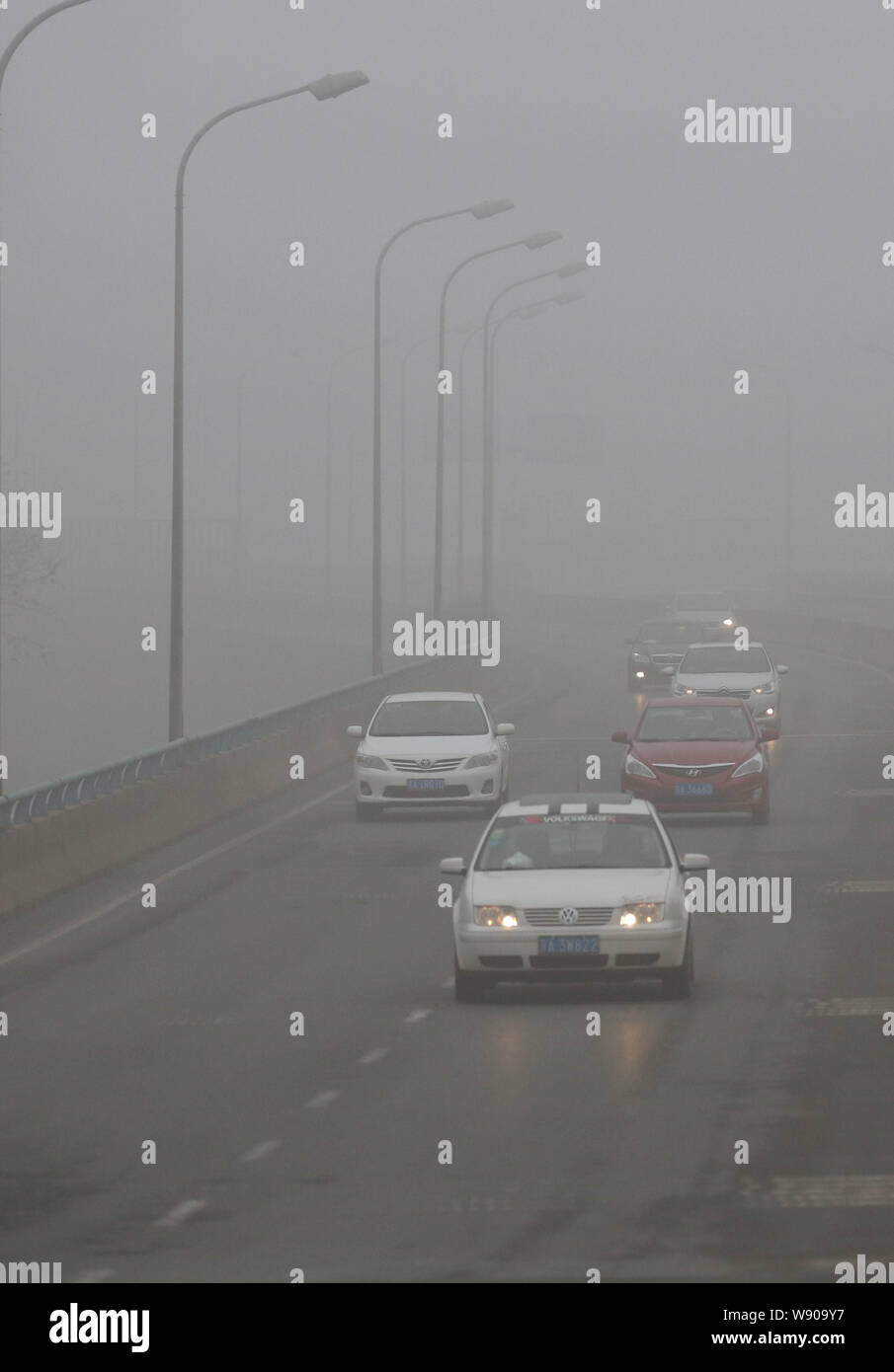 Cars travel on an elevated highway in heavy smog in Nanjing city, east ...