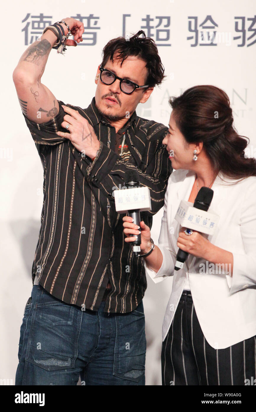 American actor Johnny Depp, left, shows the bagua tattoo on his right ...