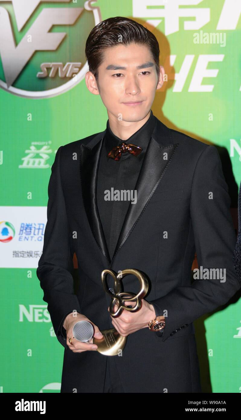 Chinese actor and singer Zhang Han poses with his trophy during the ...