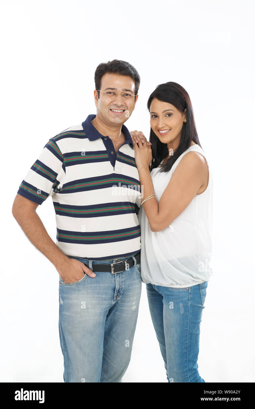Couple standing together and smiling Stock Photo - Alamy